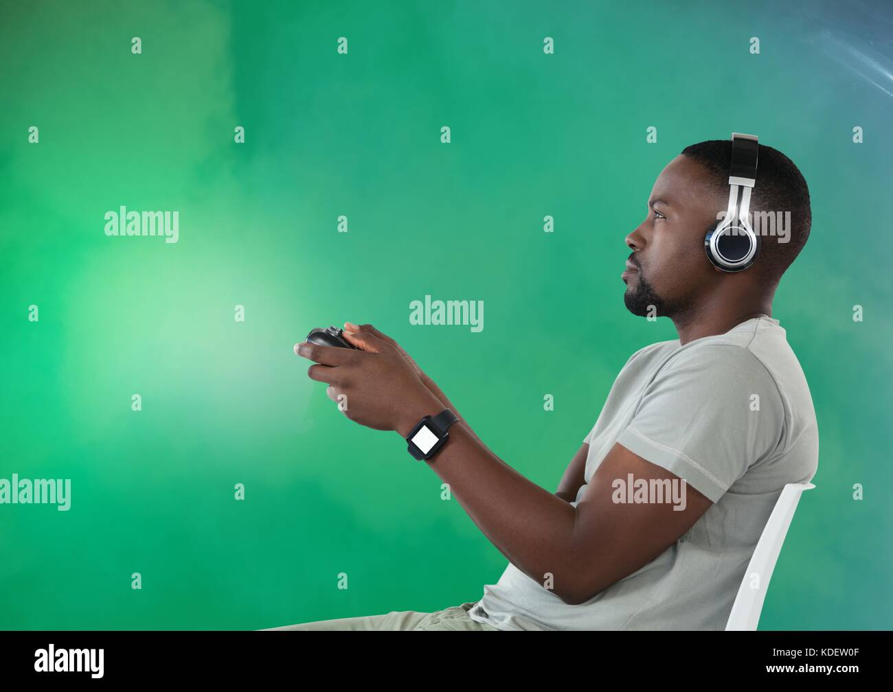Digital composite of man playing with computer game controller with ...