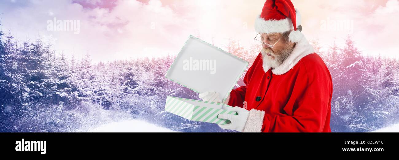Digital composite of Santa with Winter landscape and gift Stock Photo ...
