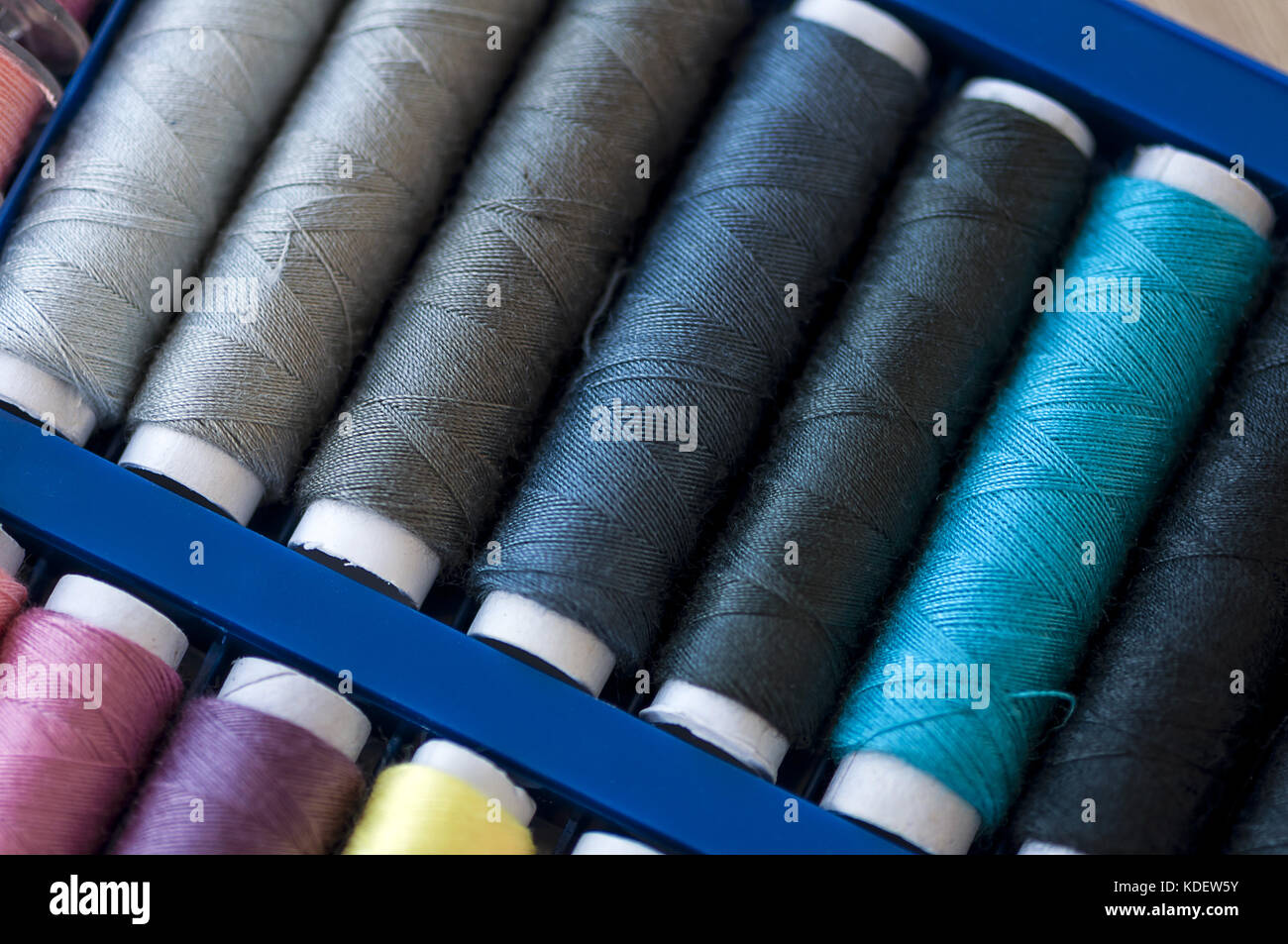 Close-up on colored sewing threads on spools Stock Photo - Alamy