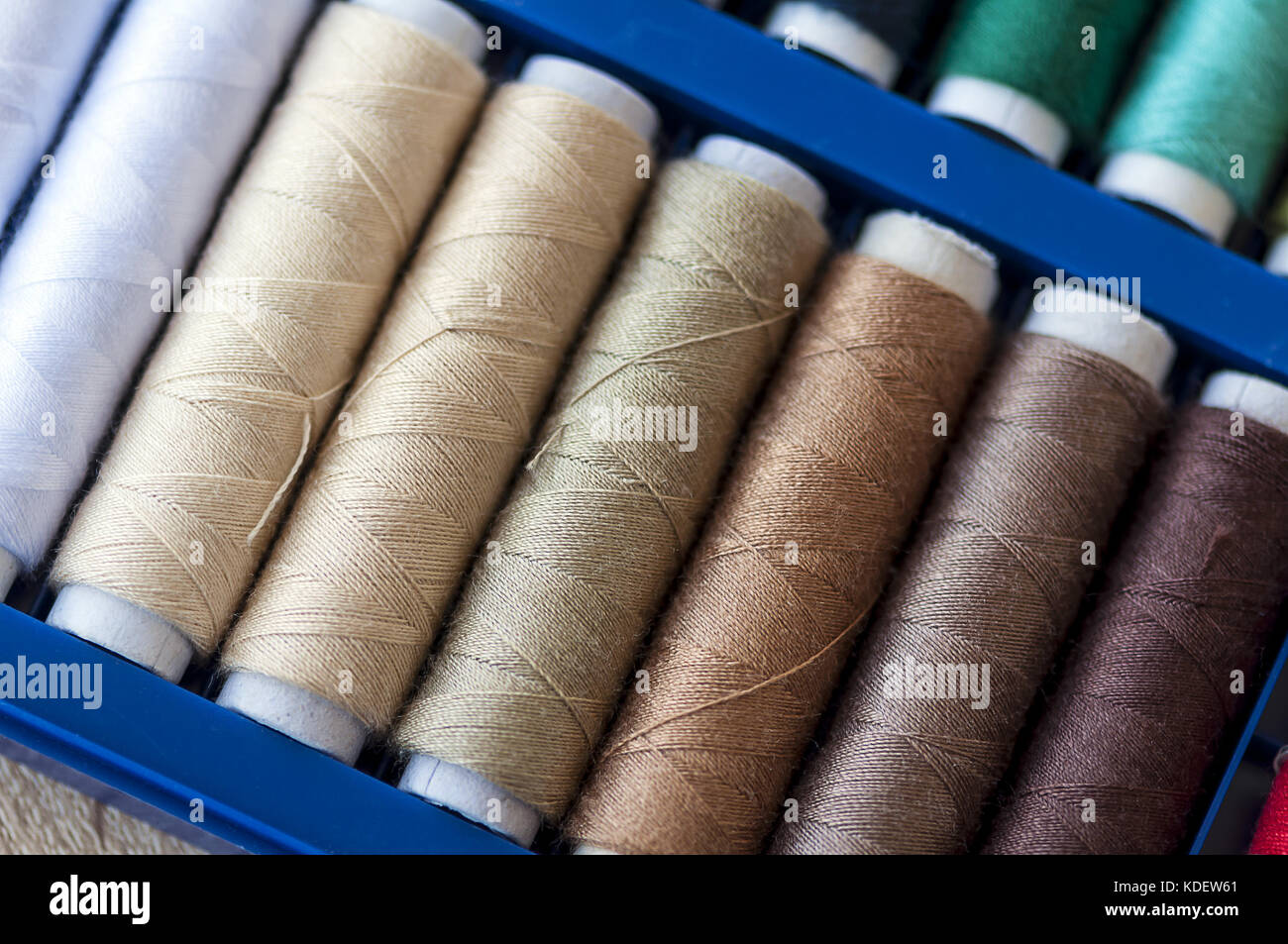 Close-up on colored sewing threads on spools Stock Photo - Alamy