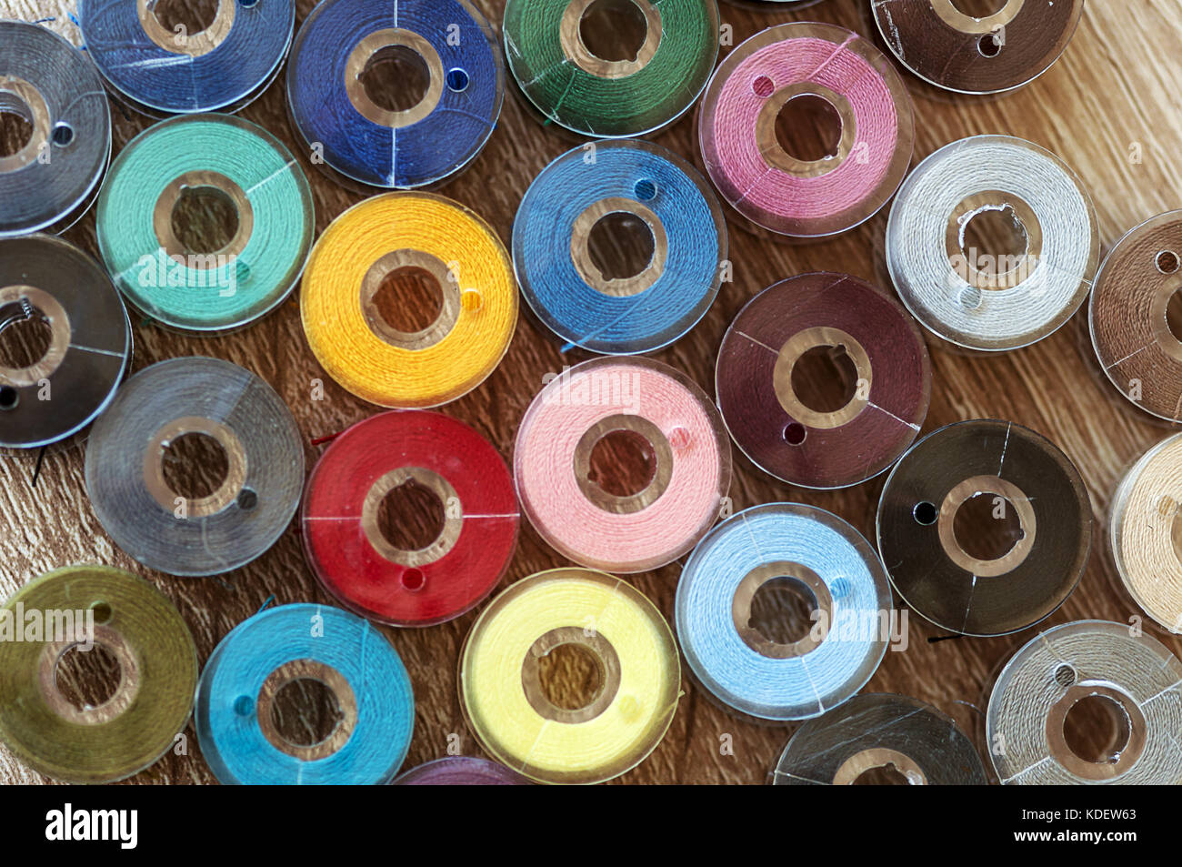 Close-up on colored sewing threads on spools. Top view Stock Photo - Alamy