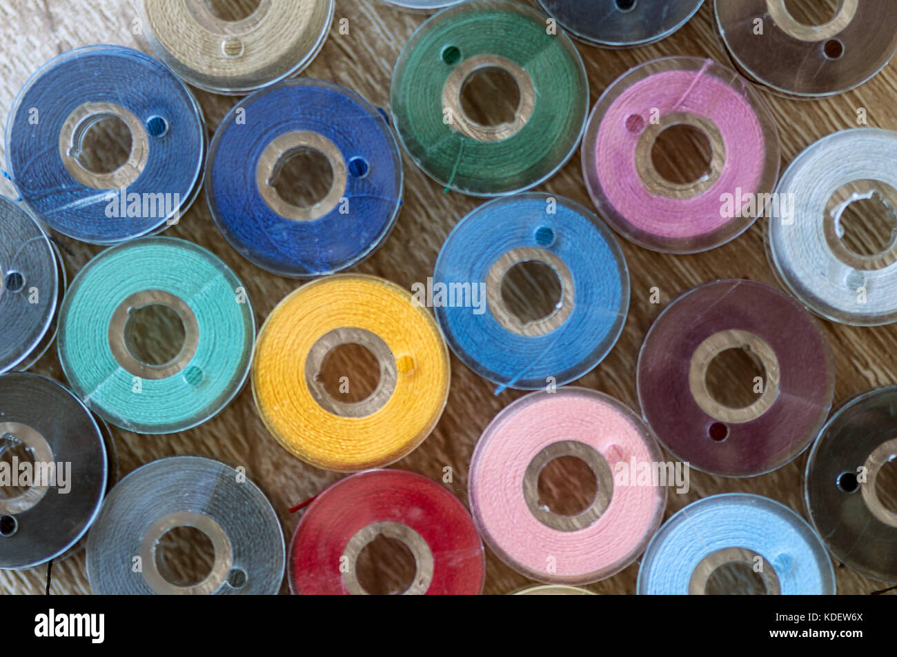 Close-up on colored sewing threads on spools. Top view Stock Photo - Alamy