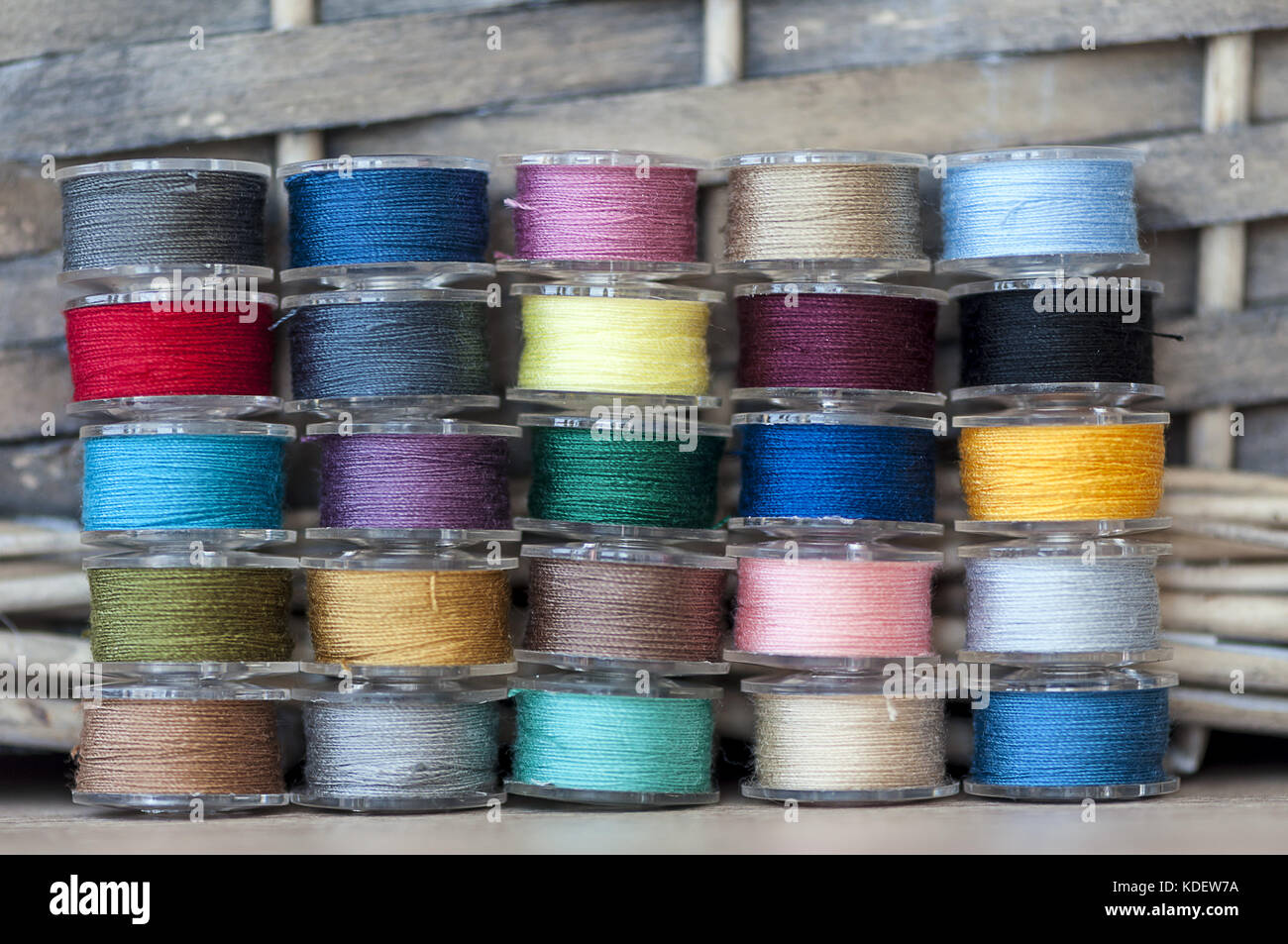 Close-up on colored sewing threads on spools Stock Photo - Alamy