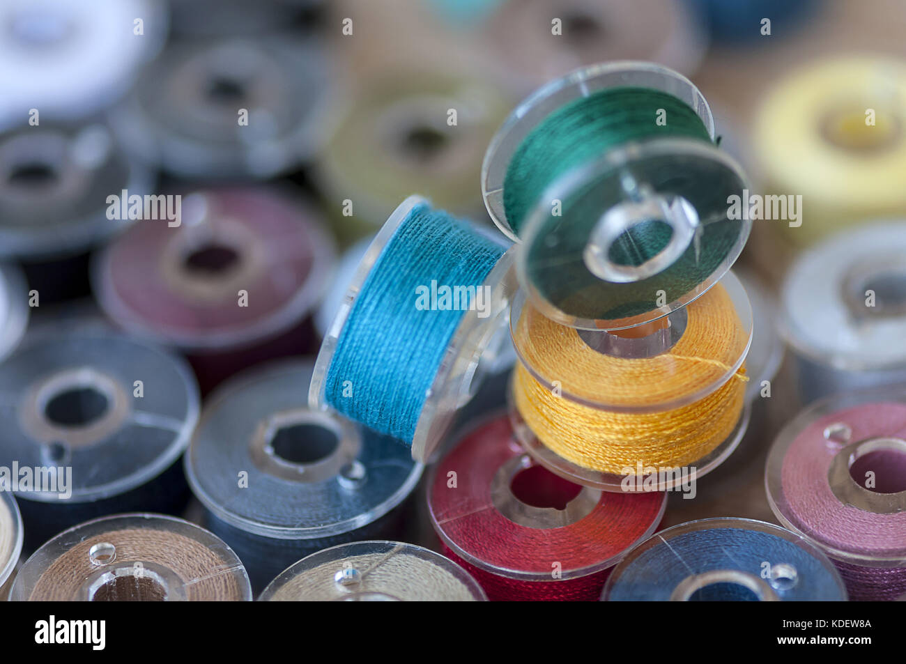 Close-up on colored sewing threads on spools Stock Photo - Alamy