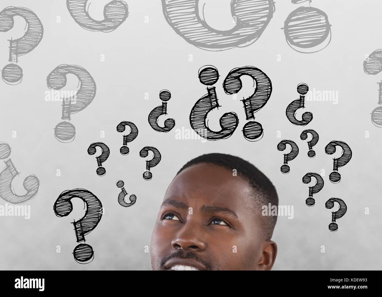 Digital composite of Man looking up at question marks Stock Photo - Alamy