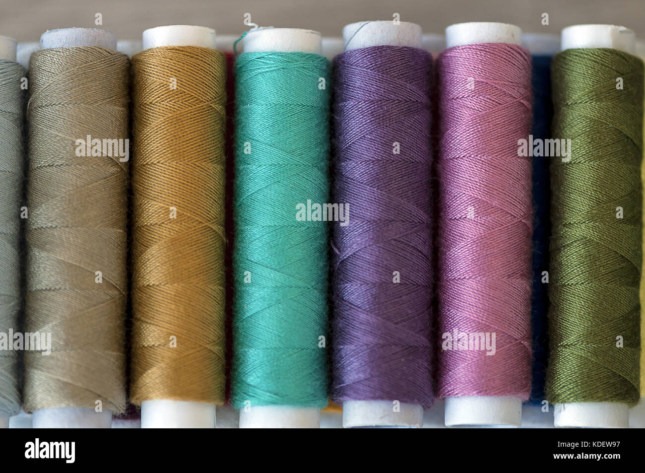 Close-up on colored sewing threads on spools Stock Photo - Alamy