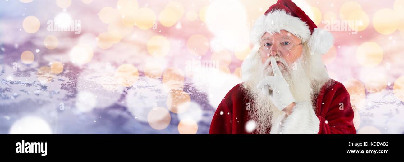 Digital composite of Santa with Winter landscape gesturing to be quiet ...