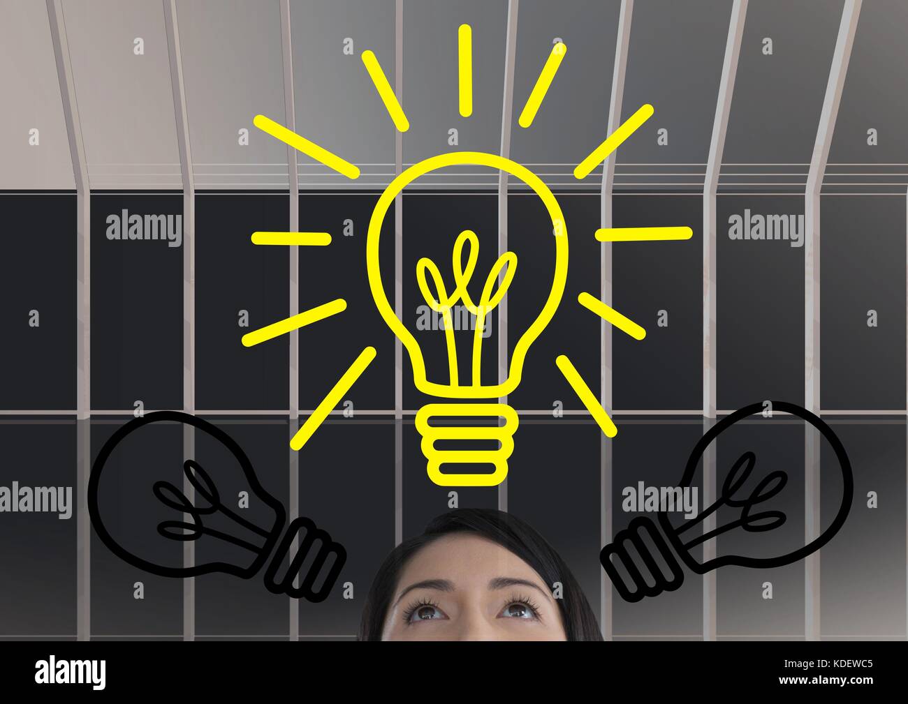 Digital composite of woman looking up at light bulb Stock Photo - Alamy