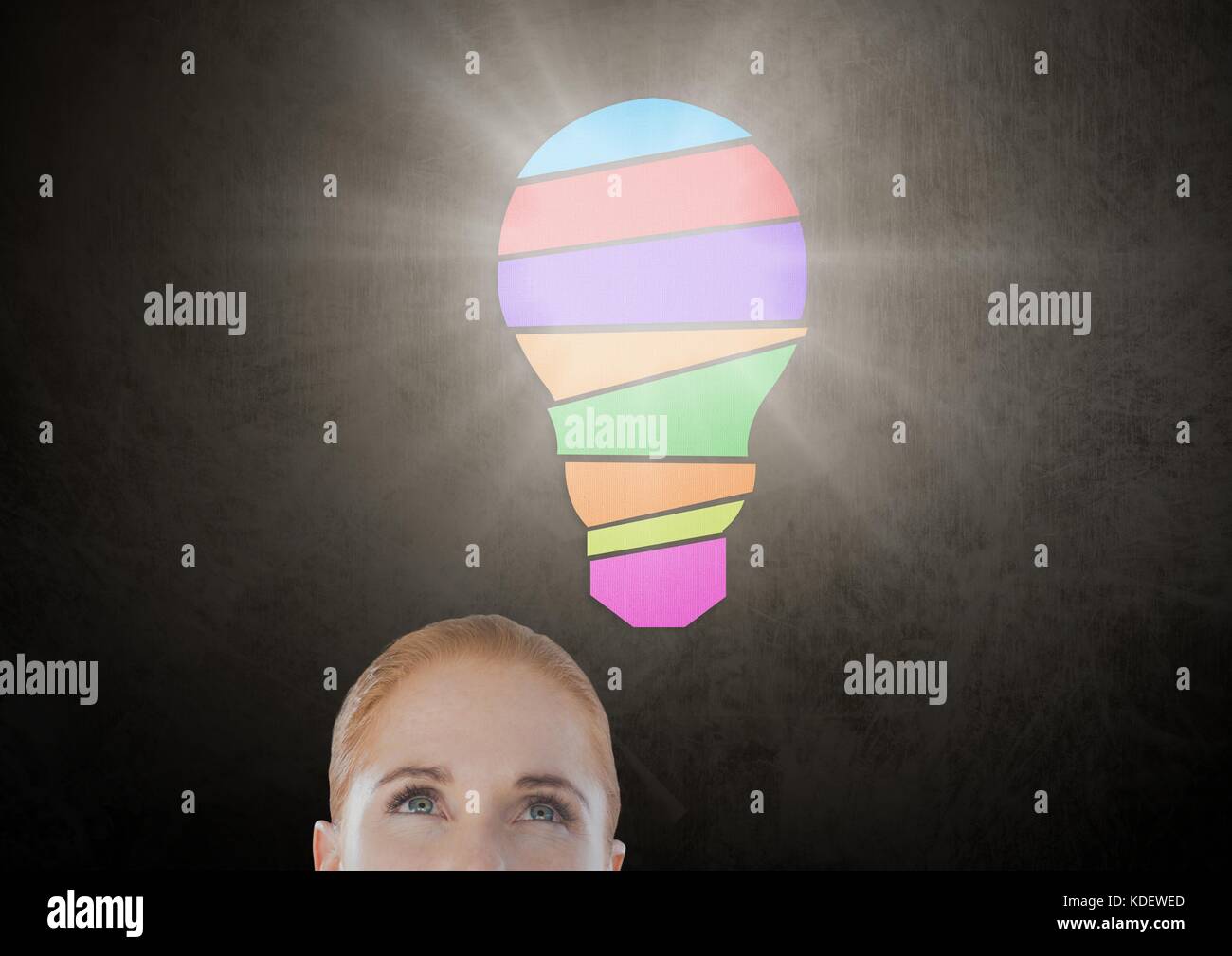 Digital composite of woman looking up at light bulb Stock Photo - Alamy