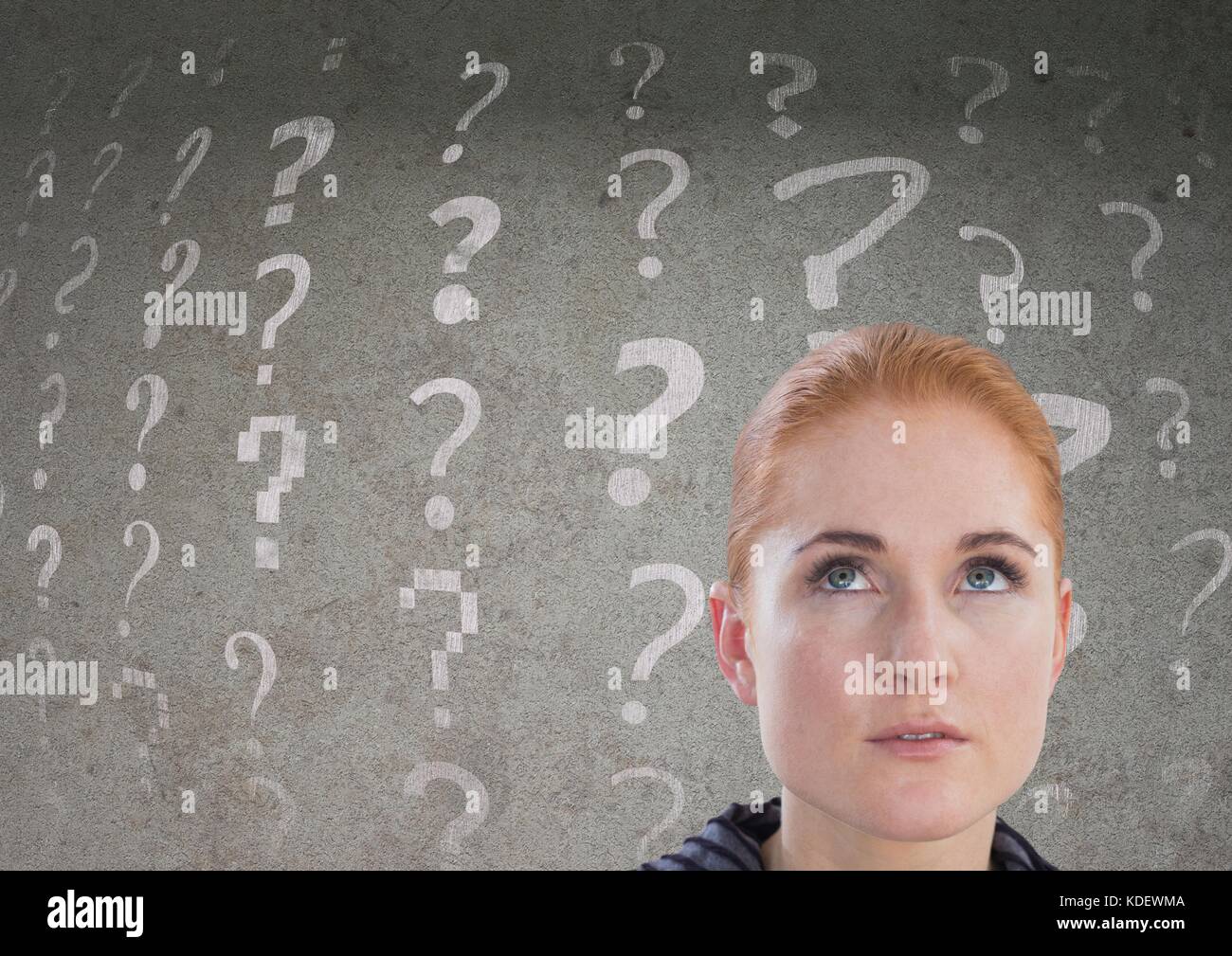 Digital composite of woman looking up at question mark Stock Photo - Alamy