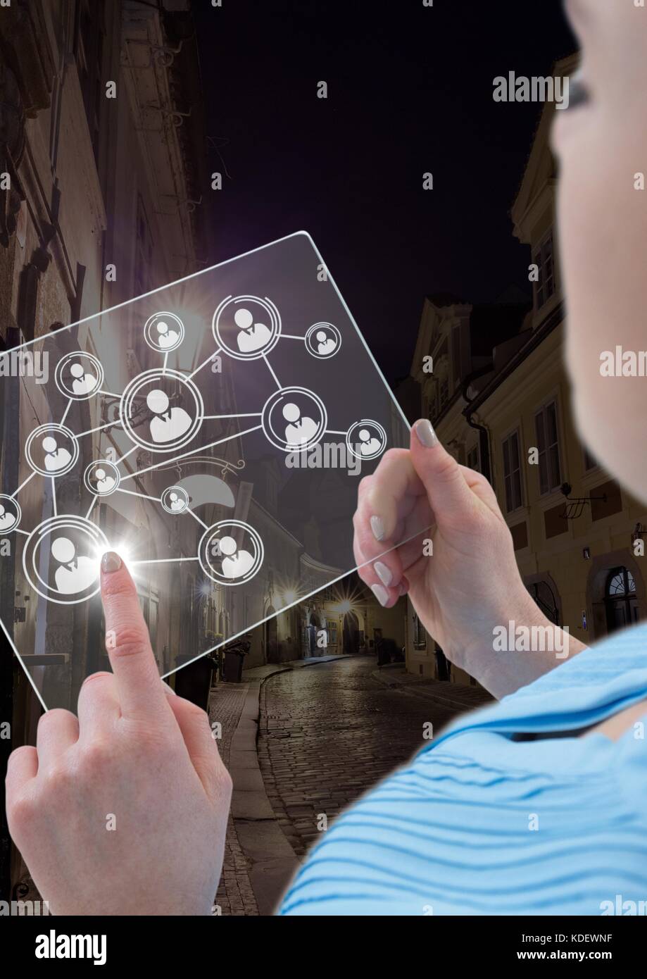 Digital composite of woman holding glass interface Stock Photo - Alamy