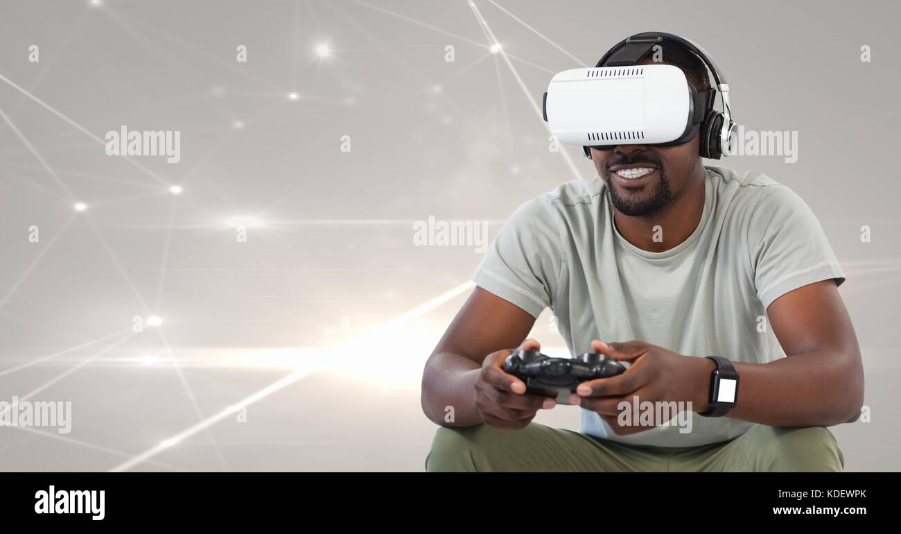 Digital composite of man playing with computer game controller with ...
