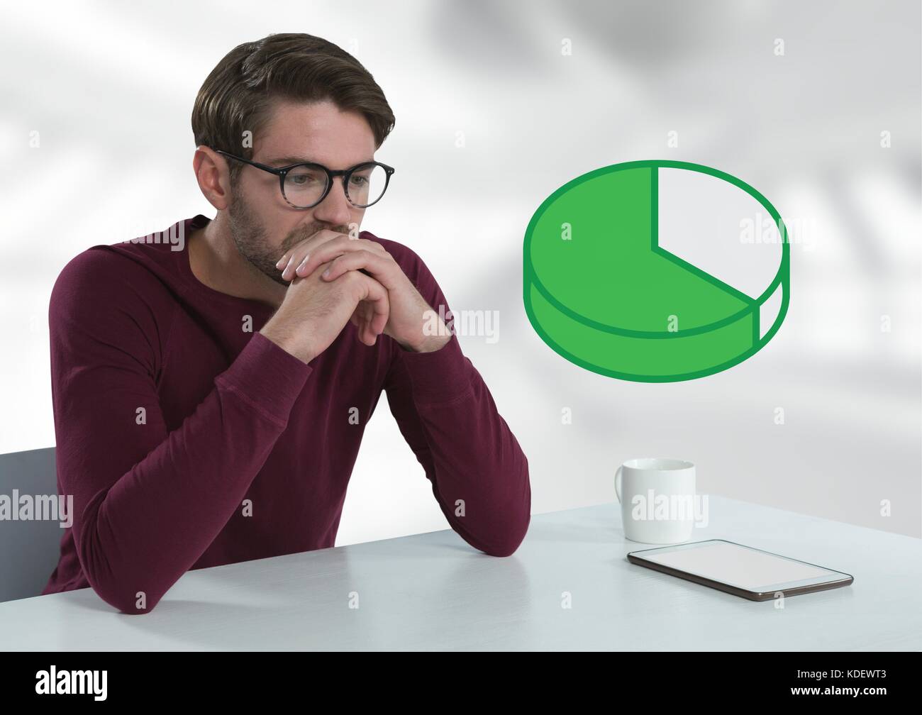 Digital composite of Businessman with tablet at desk with pie chart ...