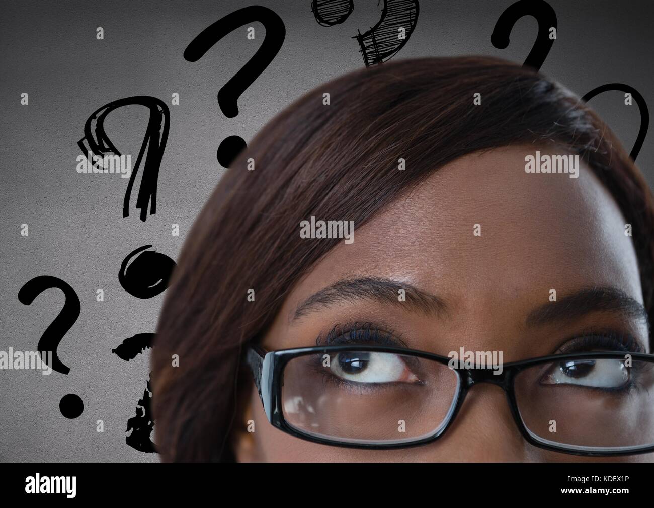 Digital composite of woman looking up at question mark Stock Photo - Alamy