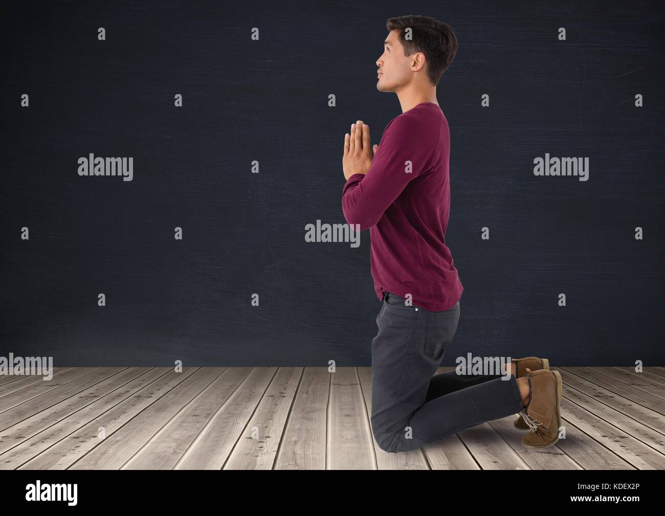 Digital composite of Man praying meditating on wooden floor Stock Photo ...