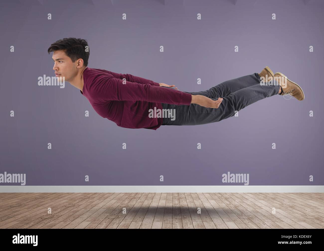 Digital composite of Man floating in room Stock Photo - Alamy