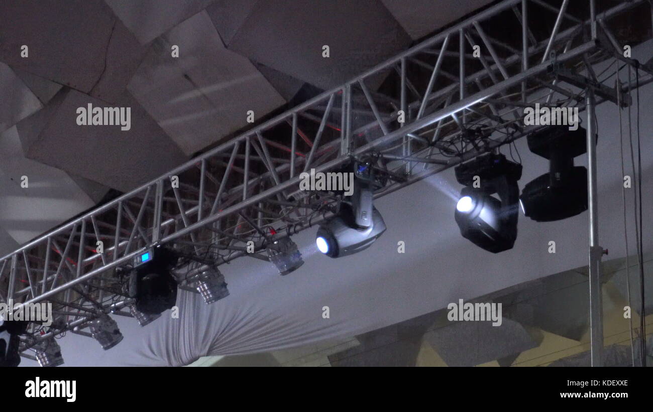 strobe lights emitting different color beams hanging under the ceiling ...