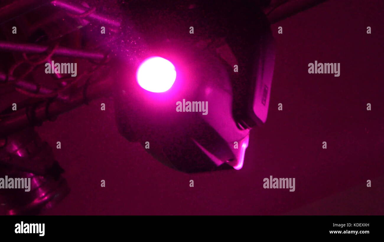 strobe lights emitting different color beams hanging under the ceiling ...