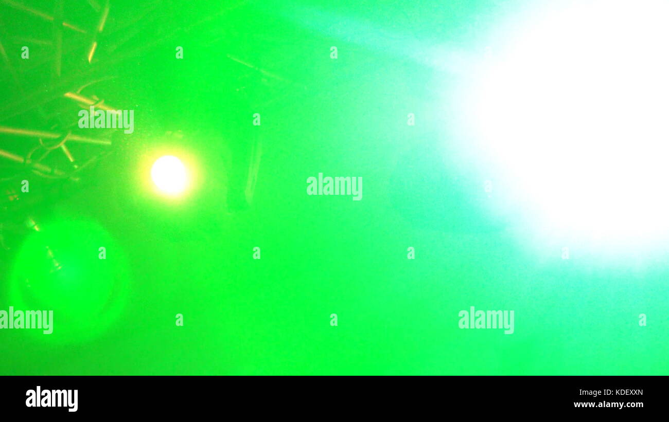 strobe lights emitting different color beams hanging under the ceiling ...