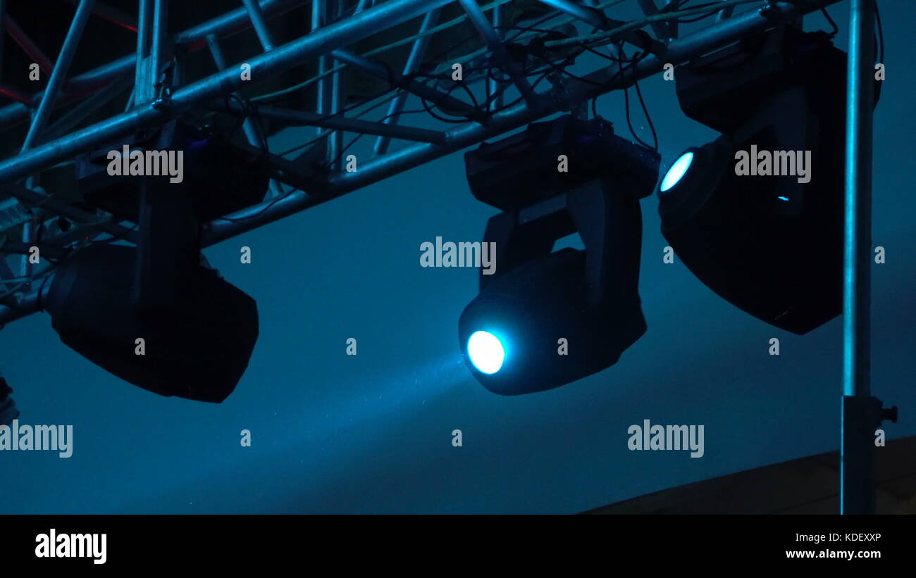 strobe lights emitting different color beams hanging under the ceiling ...