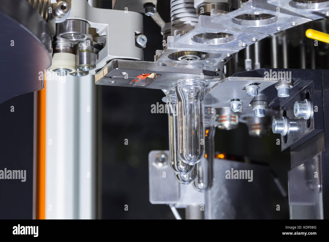 PET Preform in PET bottles blowing. The plastic bottle blowing machine ...