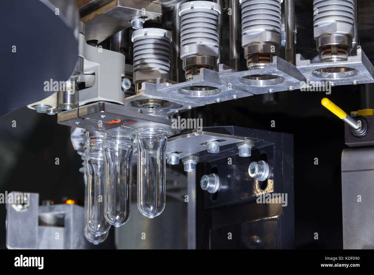 PET Preform in PET bottles blowing. The plastic bottle blowing machine ...