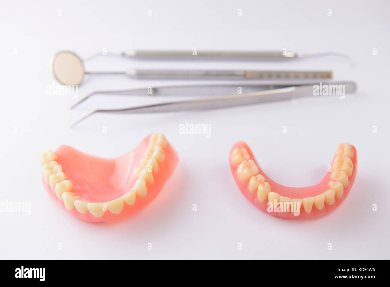 Set of false teeth and dental tools on white background Stock Photo - Alamy