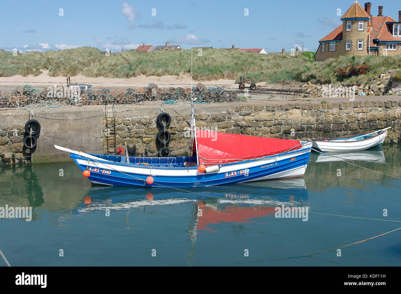 Fishing boat blue white coble hi-res stock photography and images - Alamy