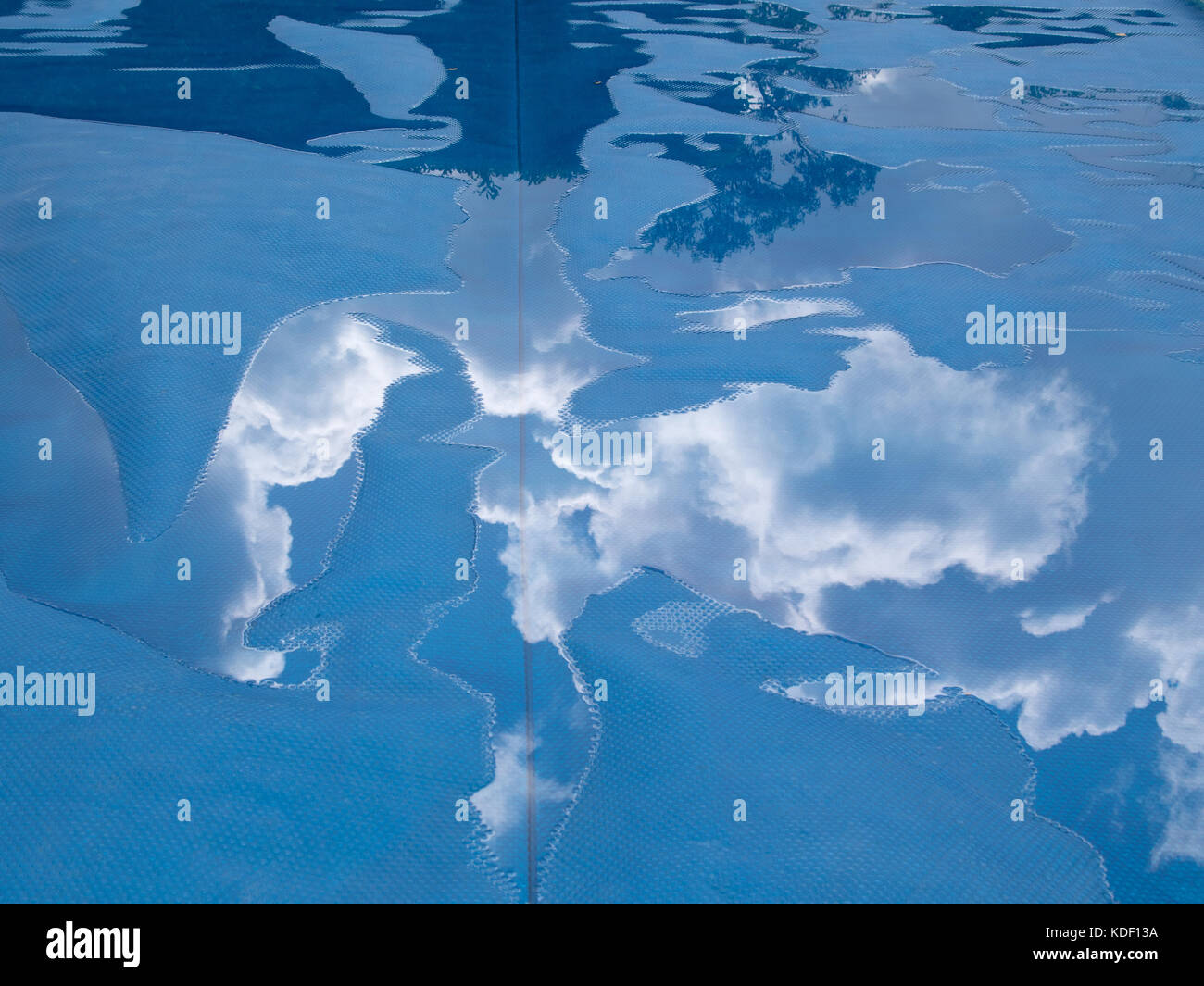 Sky and Cloud Reflections on Flooded Swimming Pool Cover Stock Photo ...