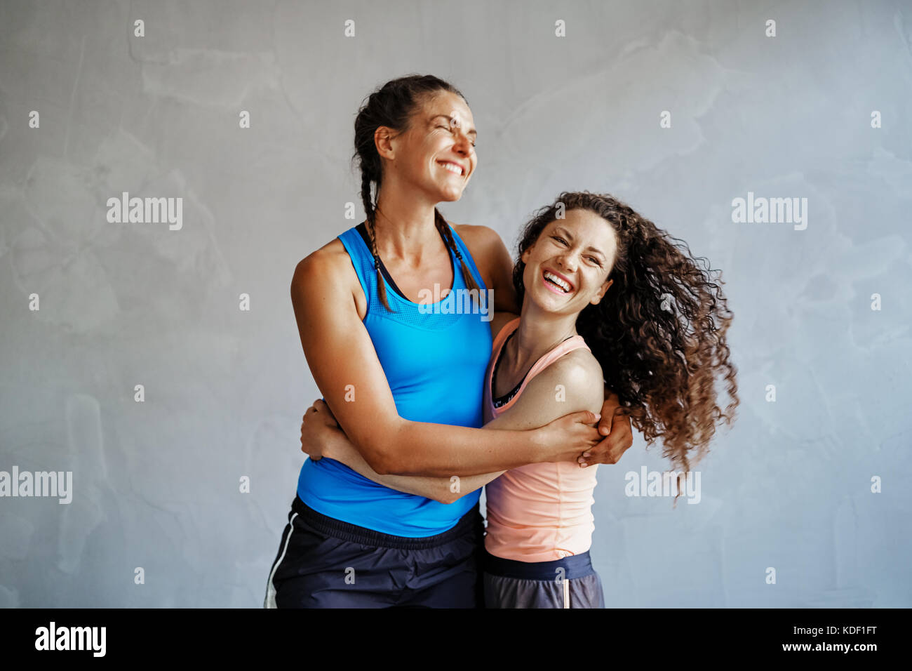 Two young women standing arm in arm hi-res stock photography and images ...
