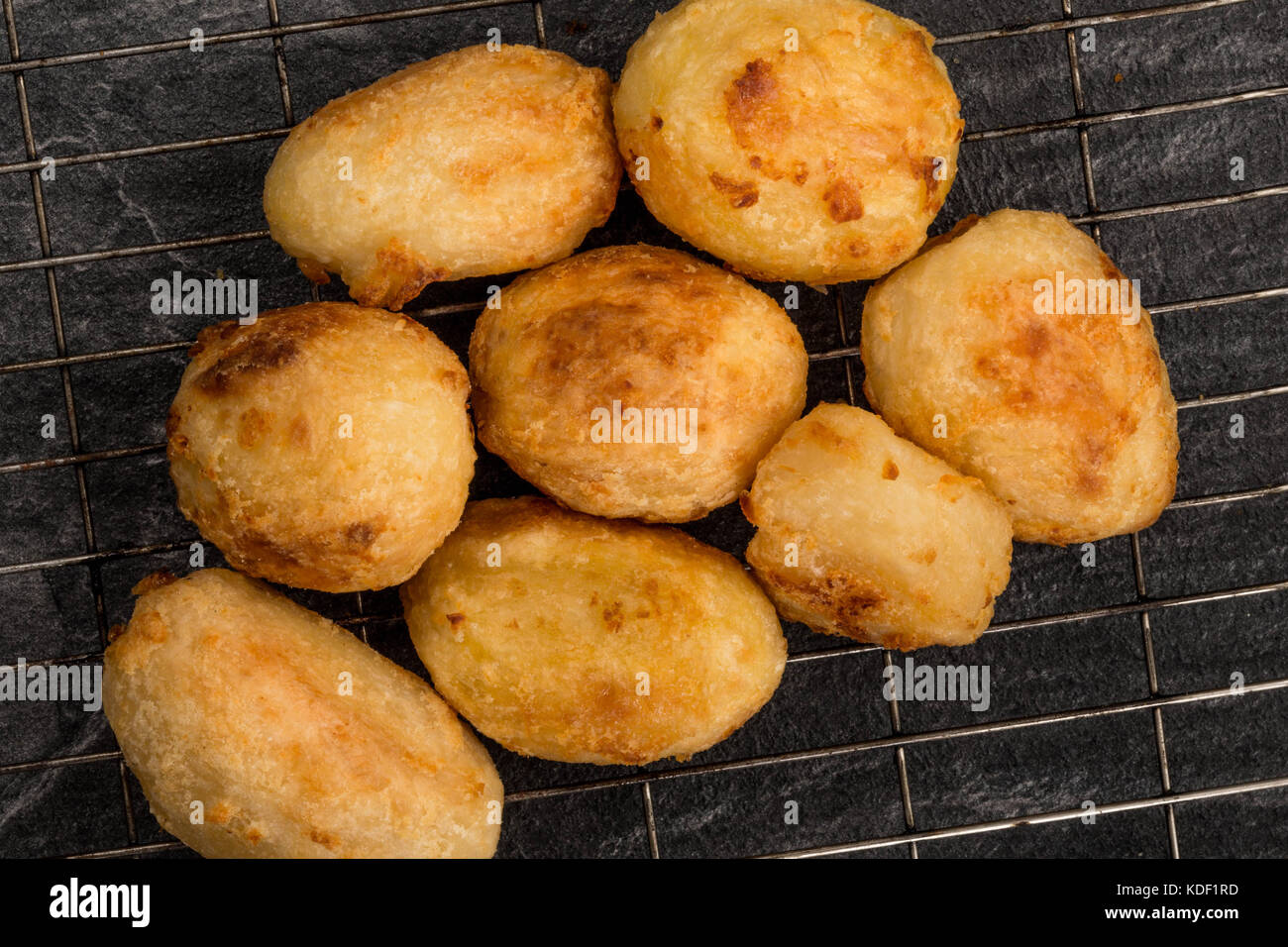 Roast Potatoes on a Steel Kitchen Cooling Rack On A Black Slate Kitchen ...