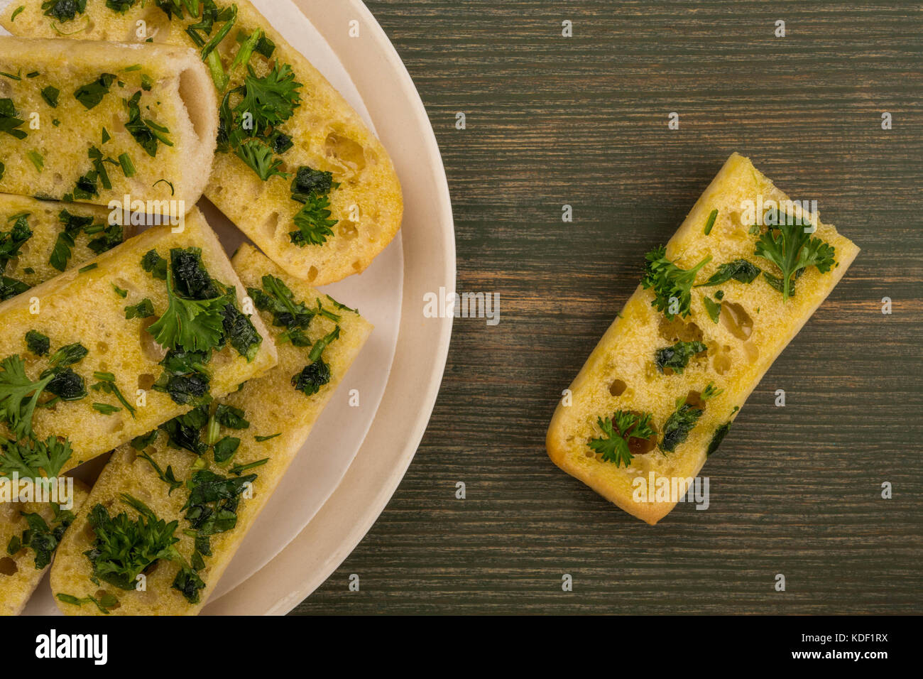 Garlic and Parsley Herbs Ciabatta Bread Sticks On A Green Wooden ...