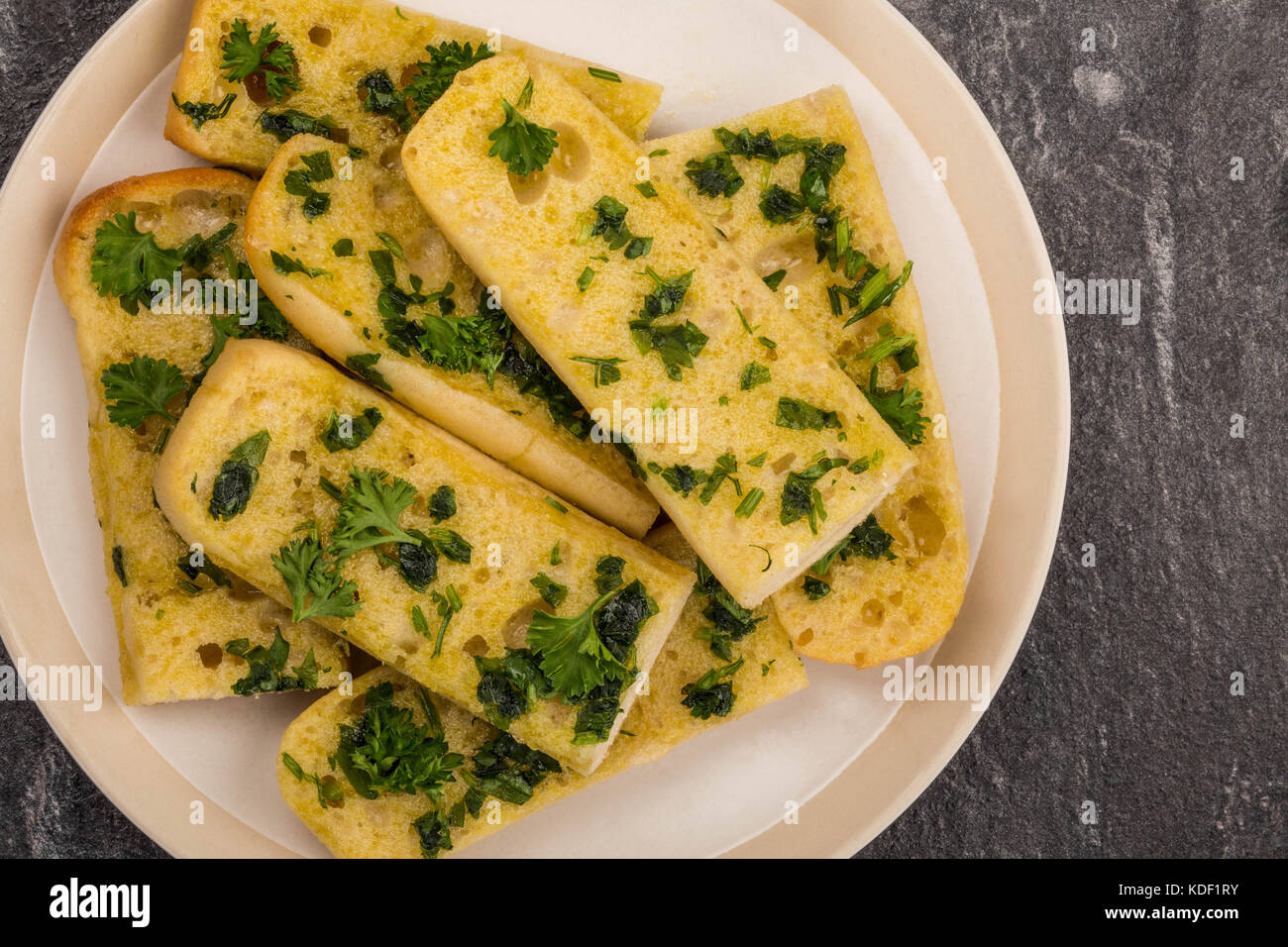 Garlic and Parsley Herbs Ciabatta Bread Sticks On A BLack Slate Kitchen ...