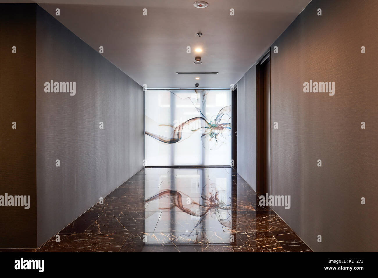 Circulation corridor featuring printed art blind. Good Life Suites ...