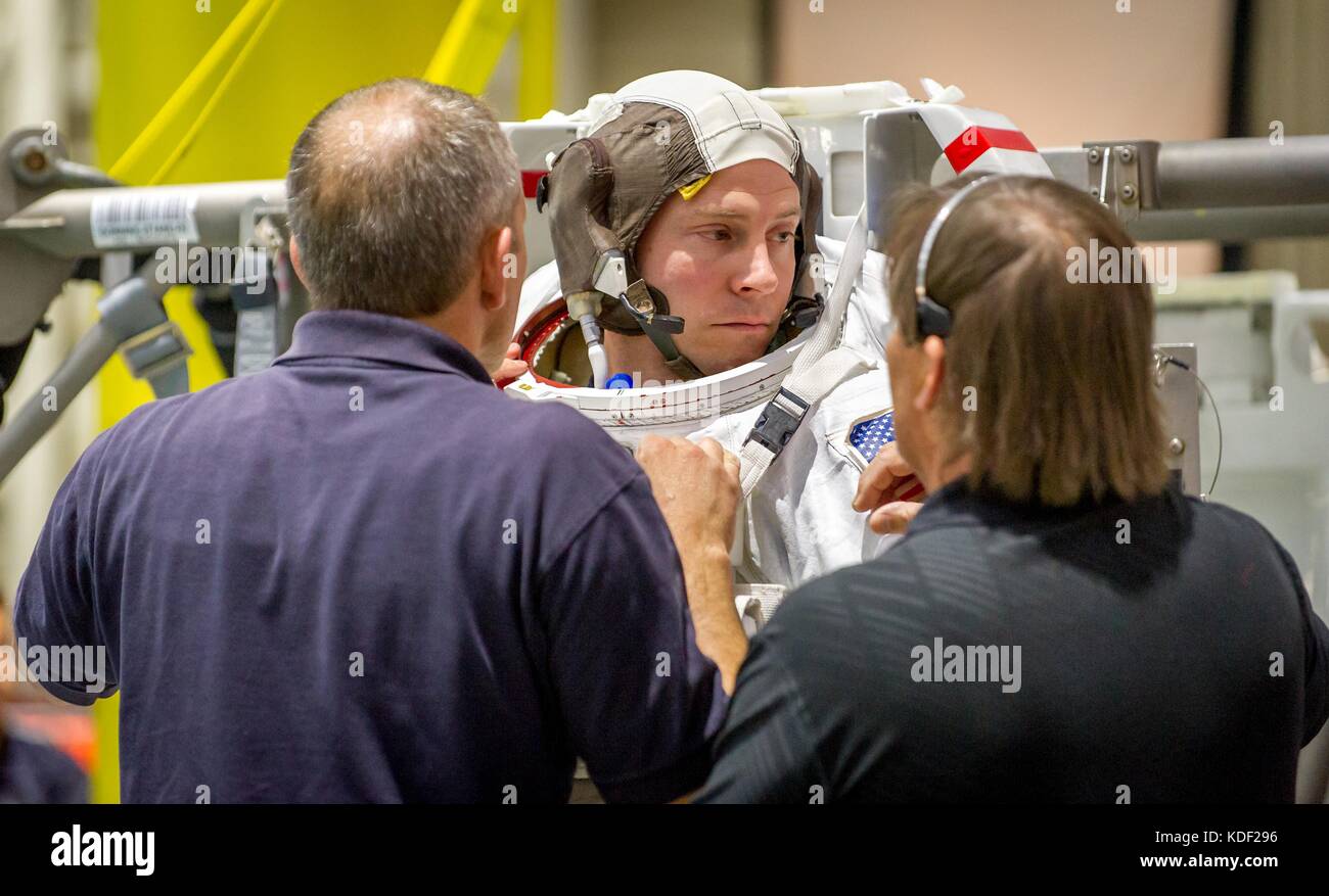 NASA astronaut Nick Hague wears a spacesuit as he prepares for ...