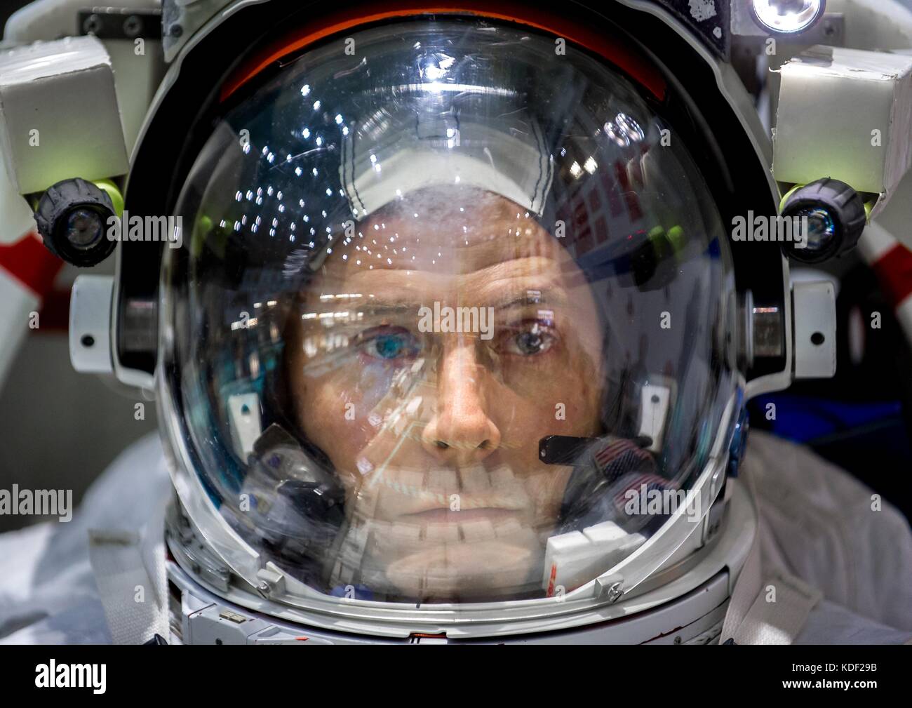 NASA astronaut Nick Hague wears a spacesuit as he prepares for ...