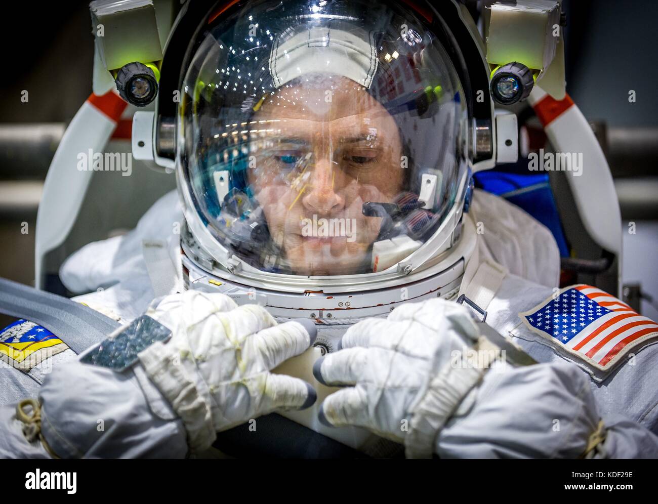 NASA astronaut Nick Hague wears a spacesuit as he prepares for ...