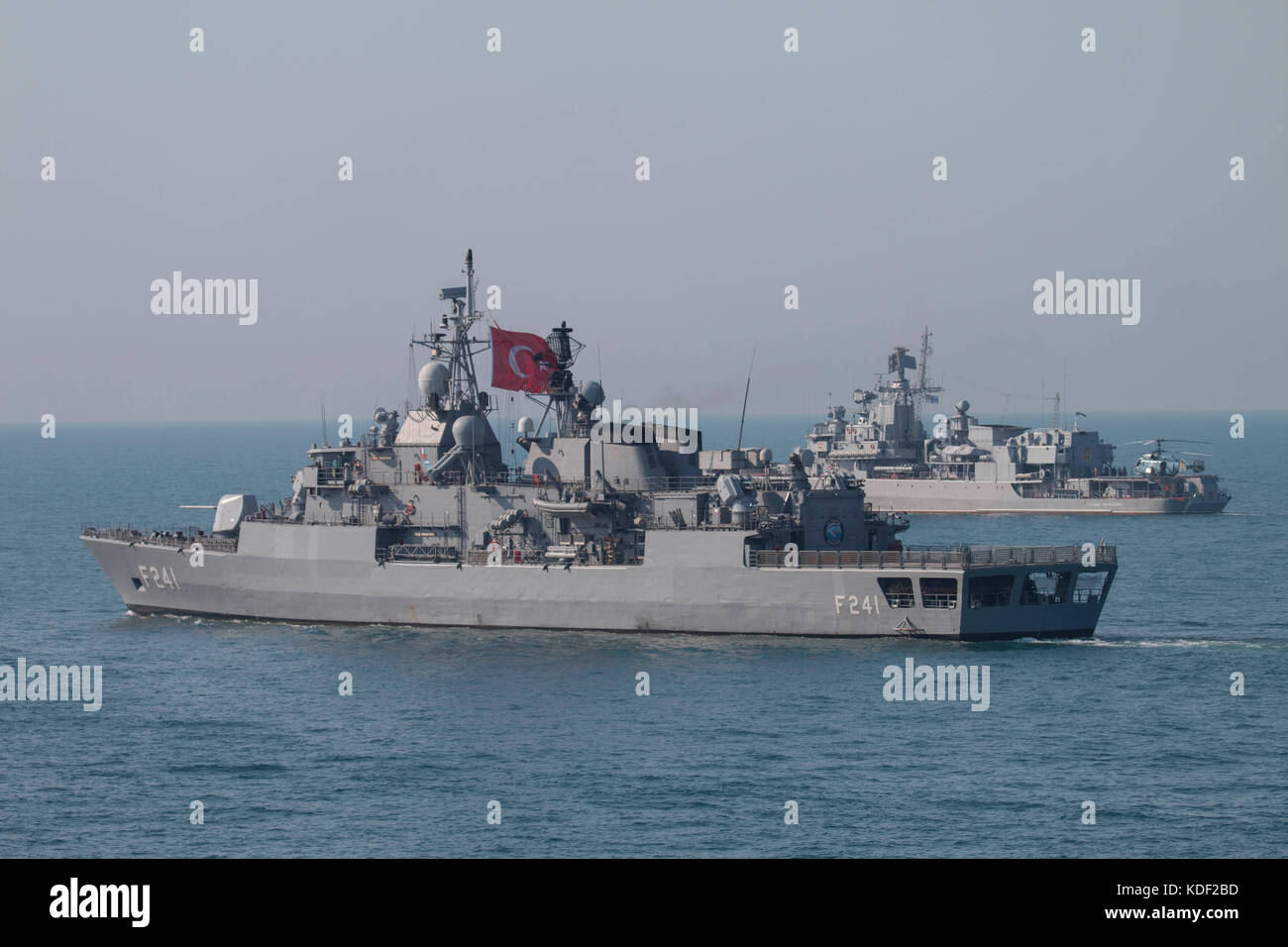 The Turkish Navy Yavuz-class frigate TCG Turgutreis (left) and the ...
