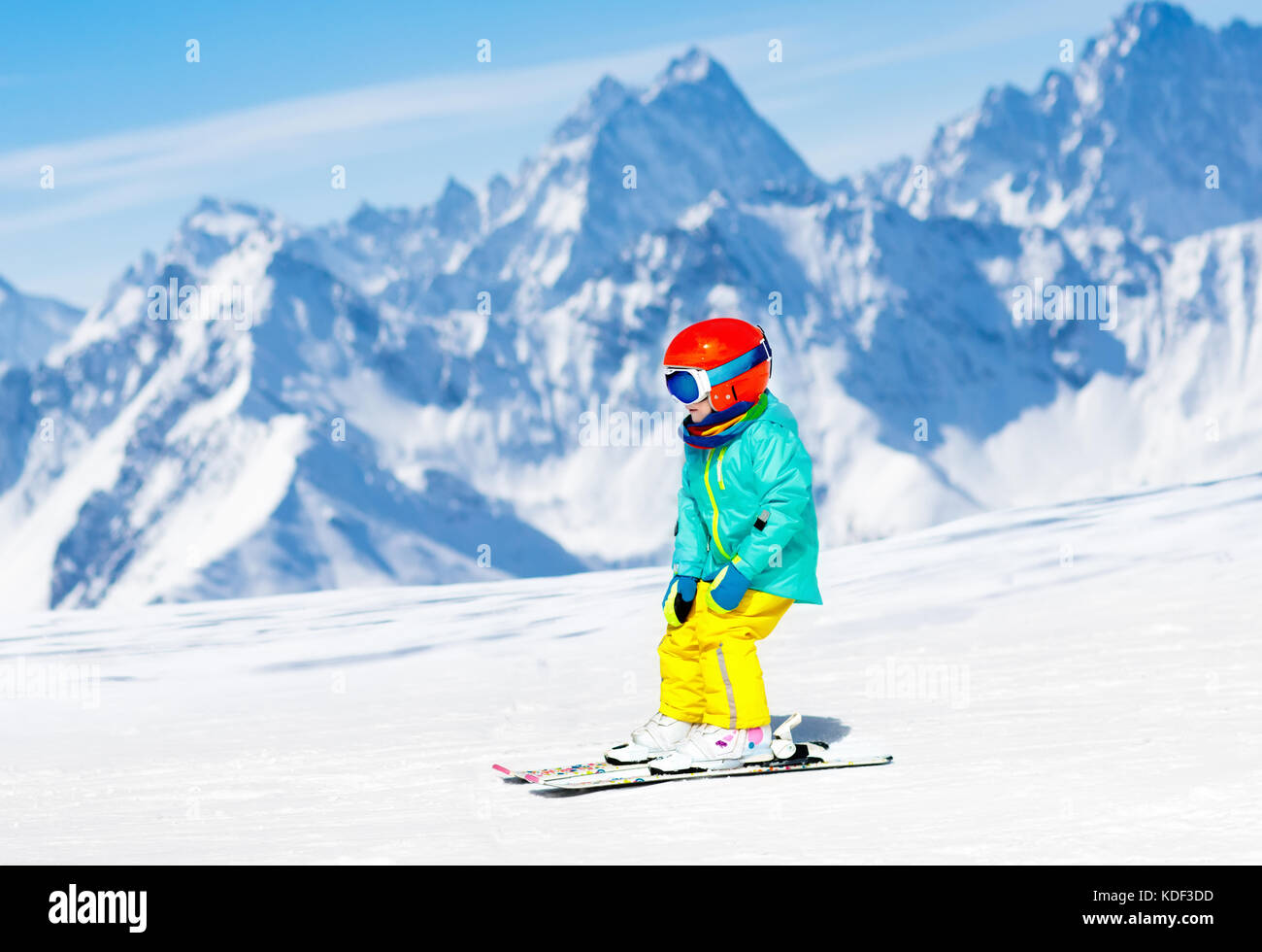 Child skiing in the mountains. Kid in ski school. Winter sport for kids ...