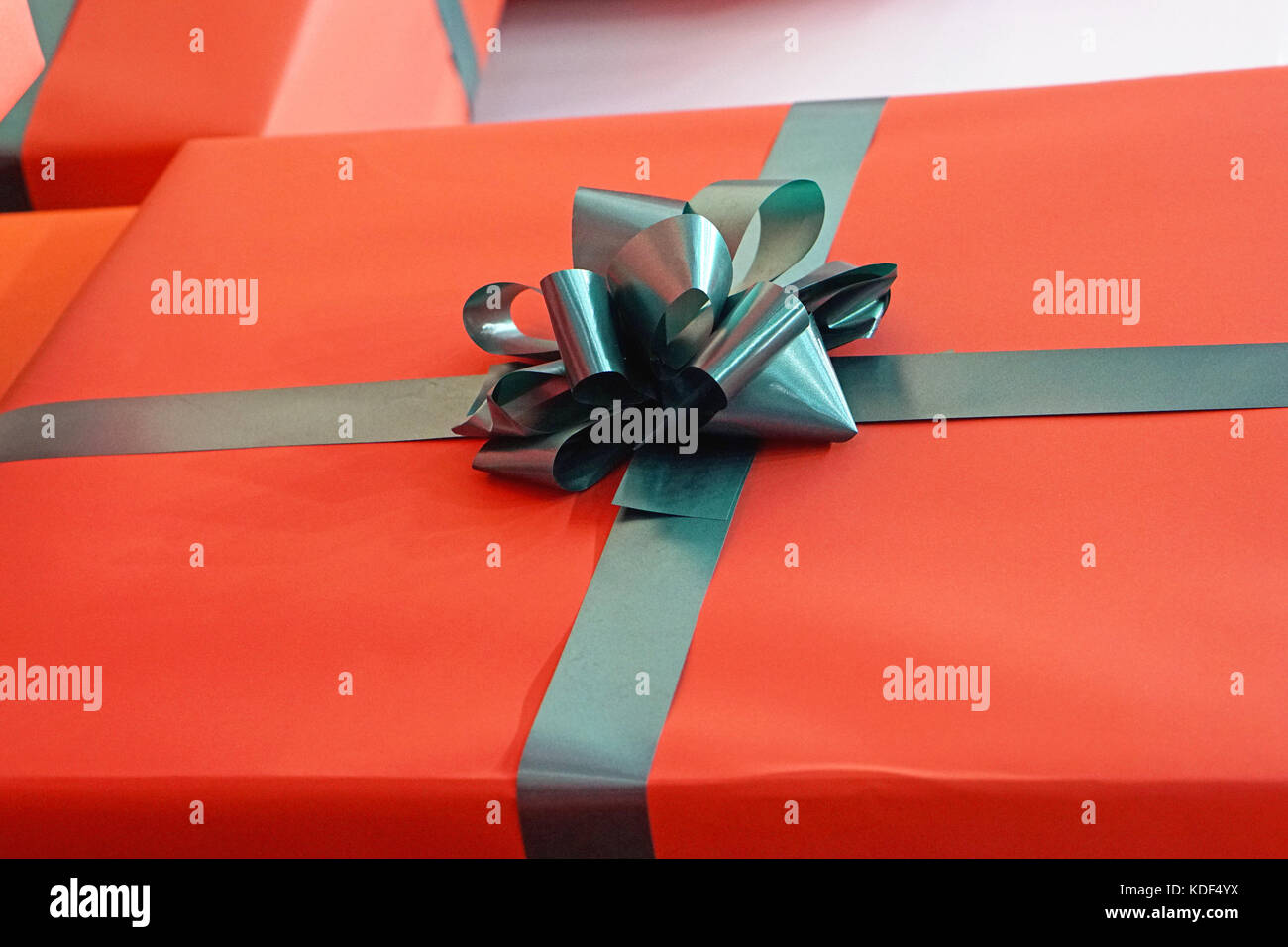 Red gift wrap with green ribbon Stock Photo - Alamy