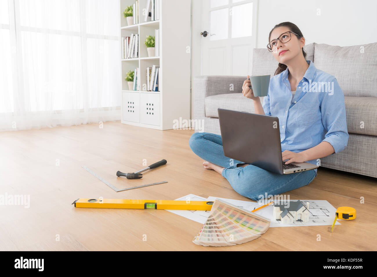 beautiful elegant female designer adviser thinking how to remodel house ...