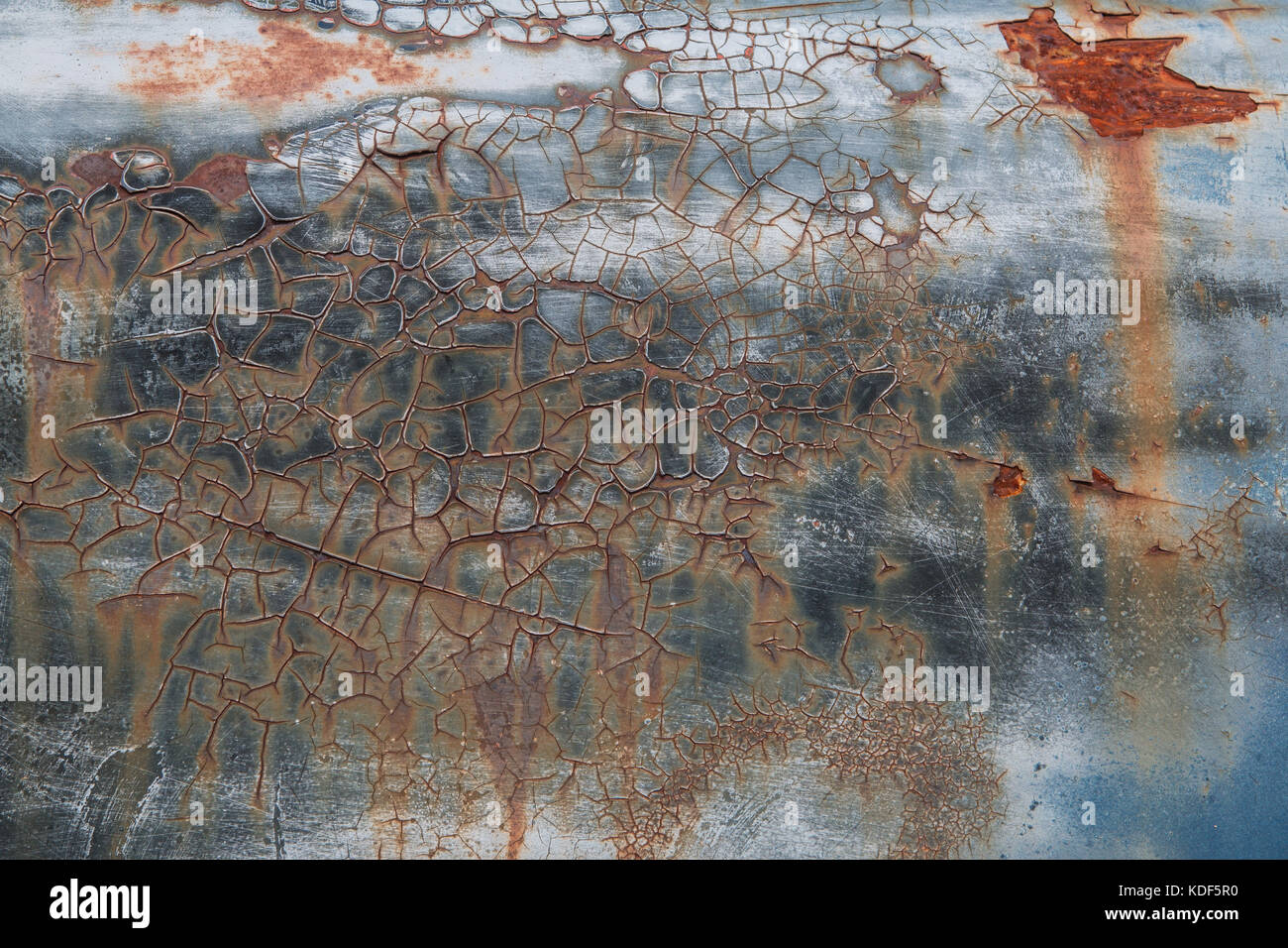 Chipped paint and rust on a junyard vehicle form an interesting grunge ...