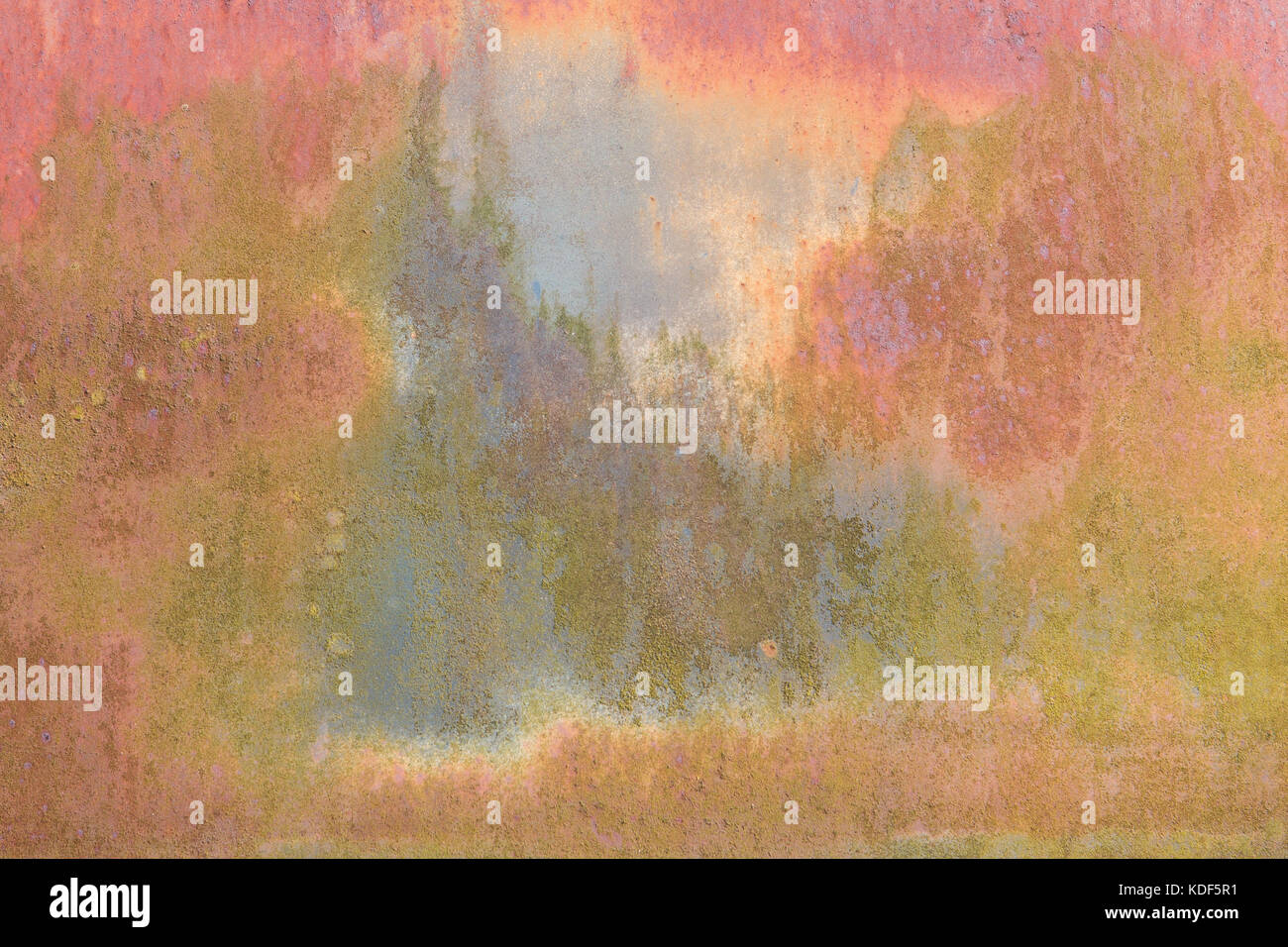 Colorful rust on a junkyard vehicle forms an interesting grunge texture ...