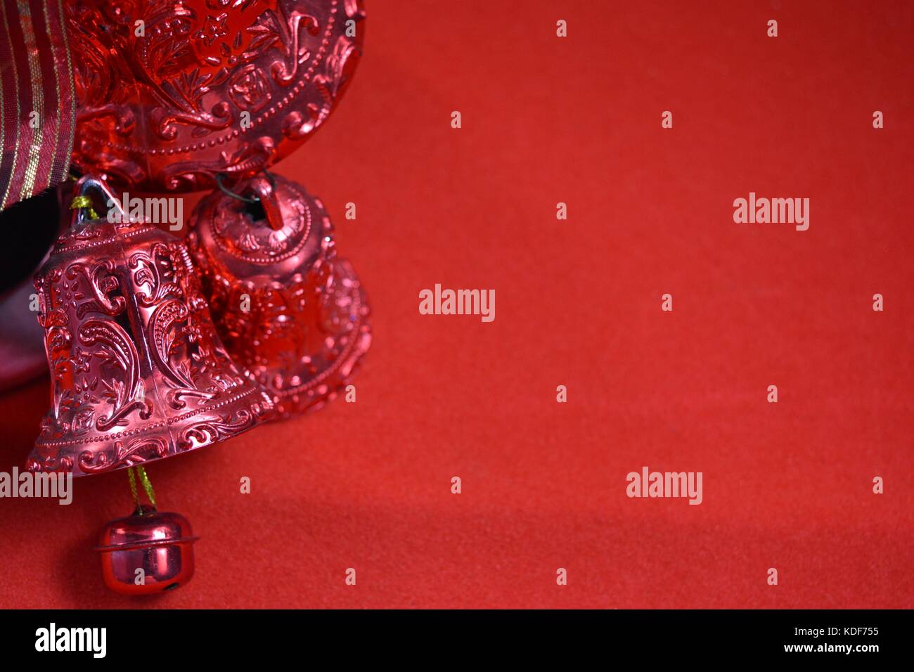 Christmas bells decoration on red background Stock Photo - Alamy