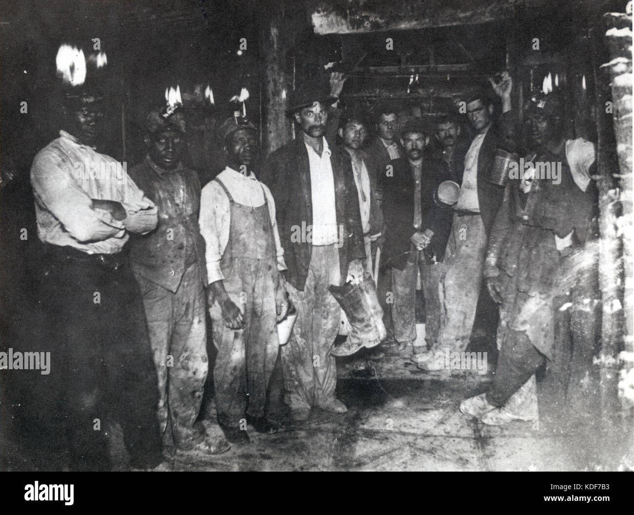 Italian and African American miners working together in a mine shaft ...