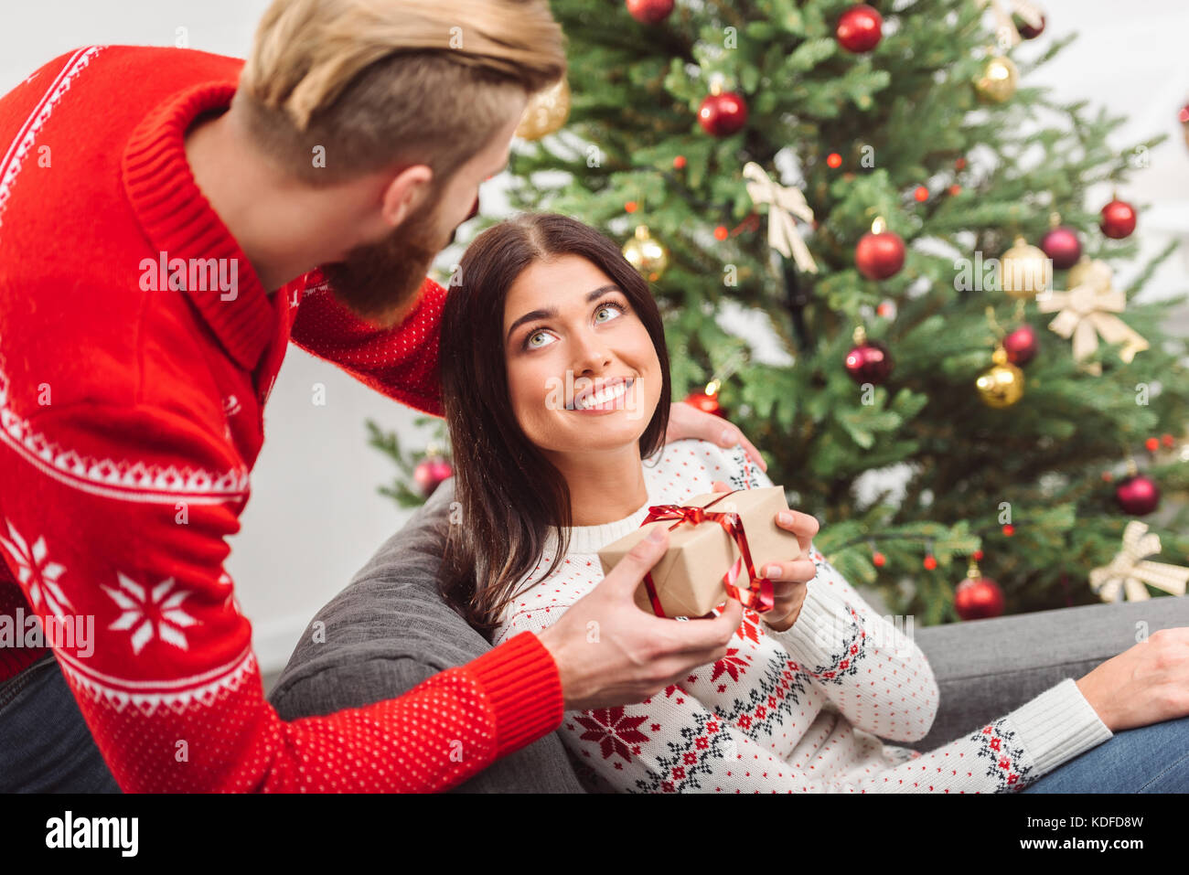 man presenting christmas gift to girlfriend Stock Photo - Alamy