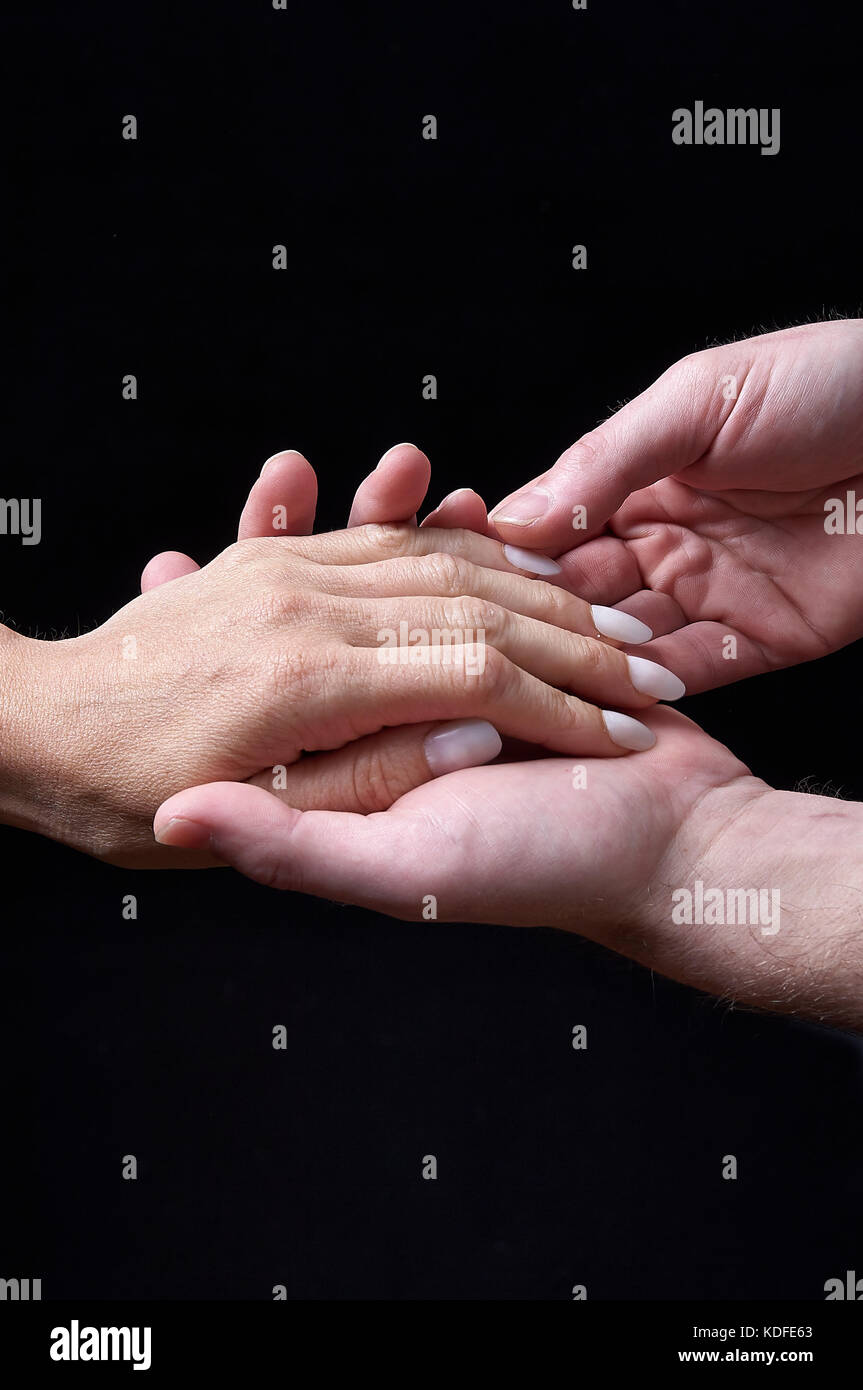 Male and female hands together on black background Stock Photo - Alamy