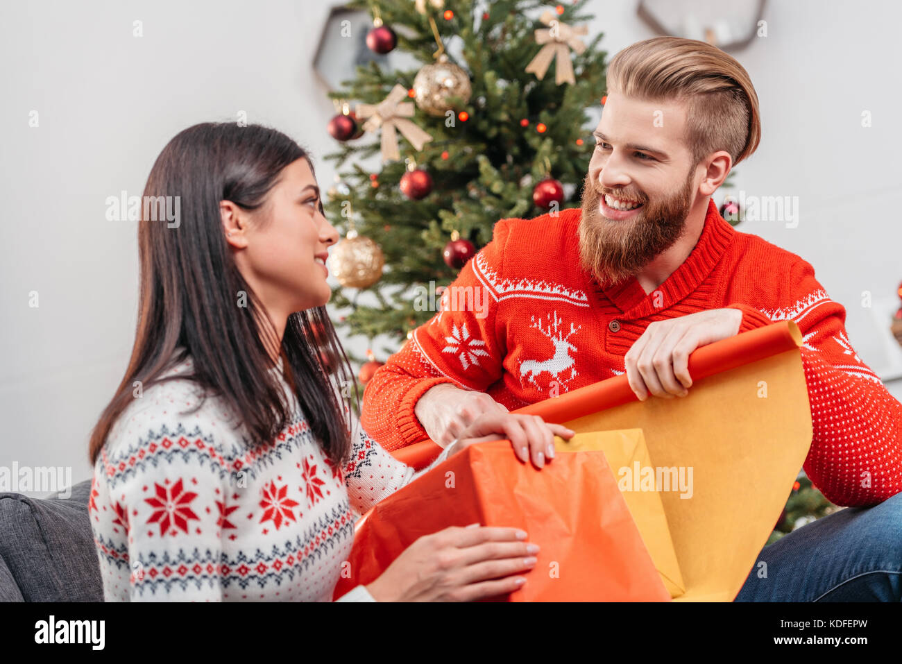 couple wrapping christmas present Stock Photo - Alamy