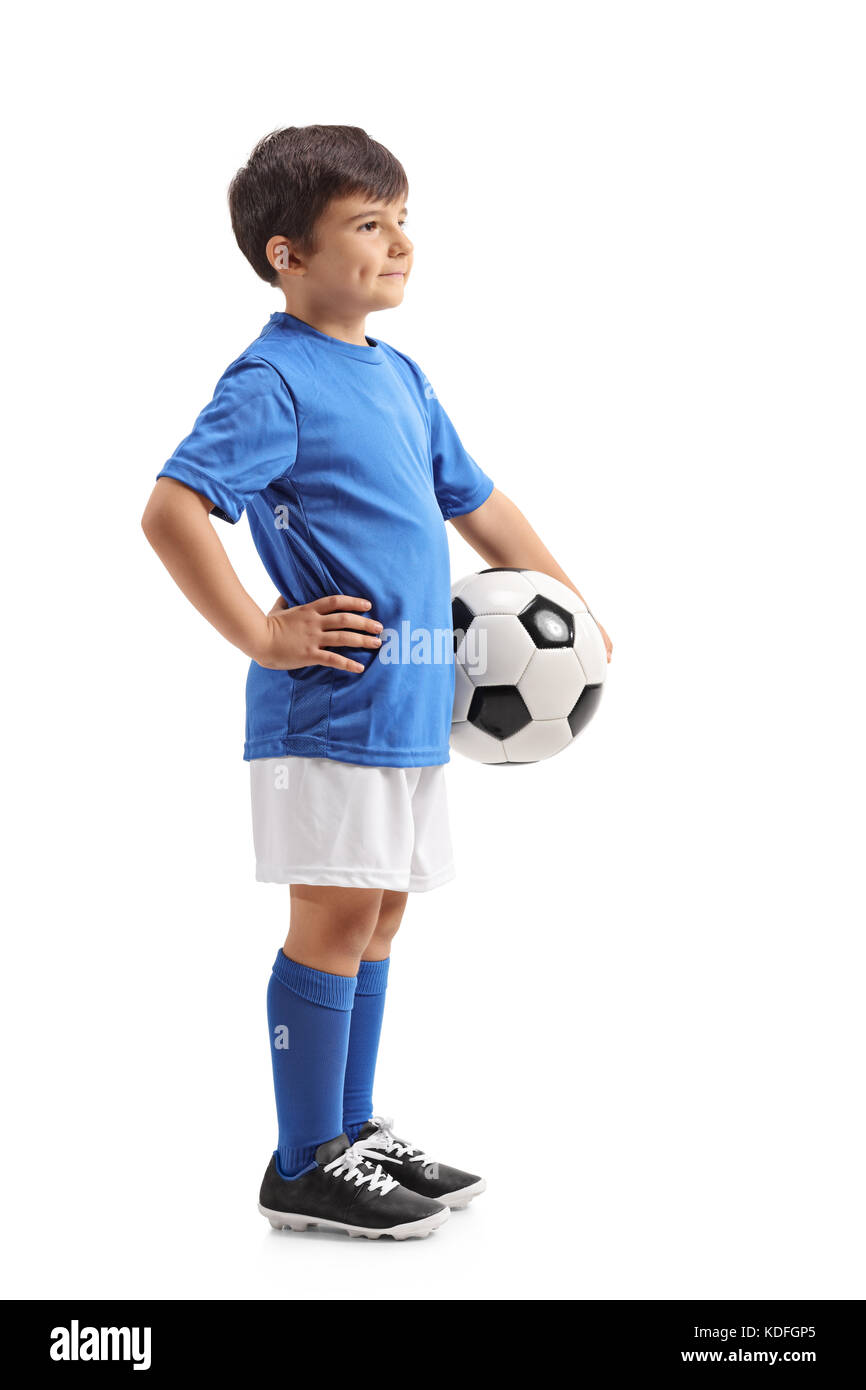 Full length profile shot of a little soccer player with a football ...