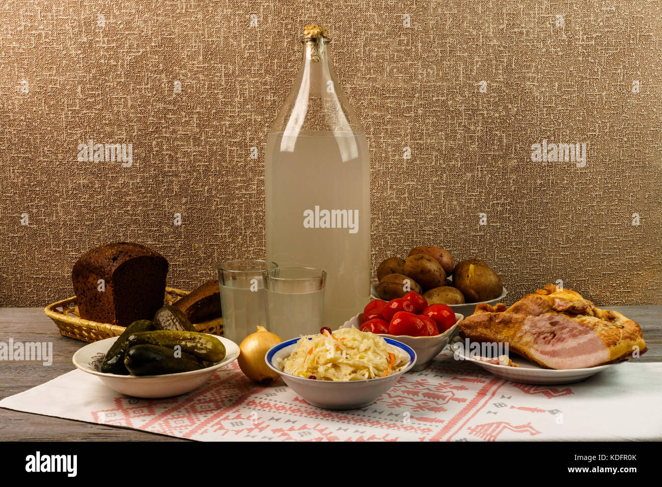 Ukrainian national drink and snack. The bottle and glass of moonshine ...